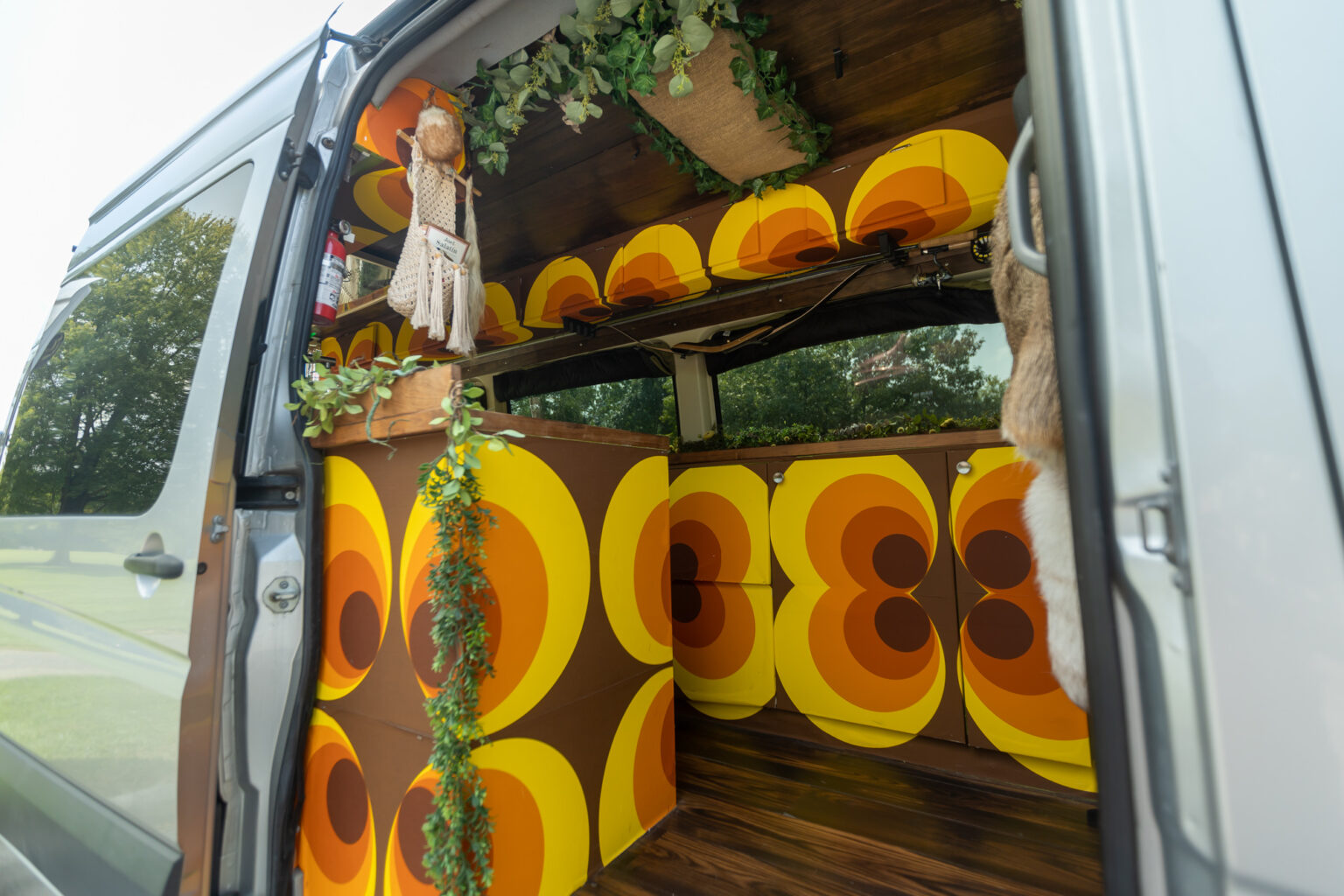 Retro Van Conversion with 70s Wallpaper Cabinets and Convertible Dinette