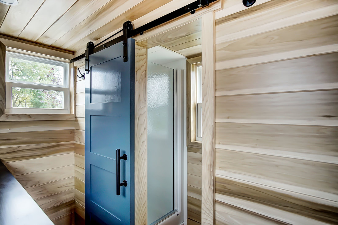 The Baby Blue Hatteras Tiny House by Modern Tiny Living