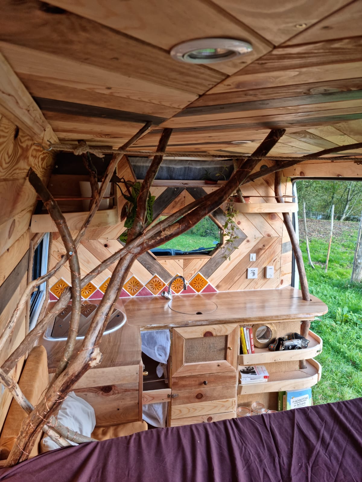 Recycle Inn Van Conversion: Reclaimed Wood Build with Tree Branch Sculpture