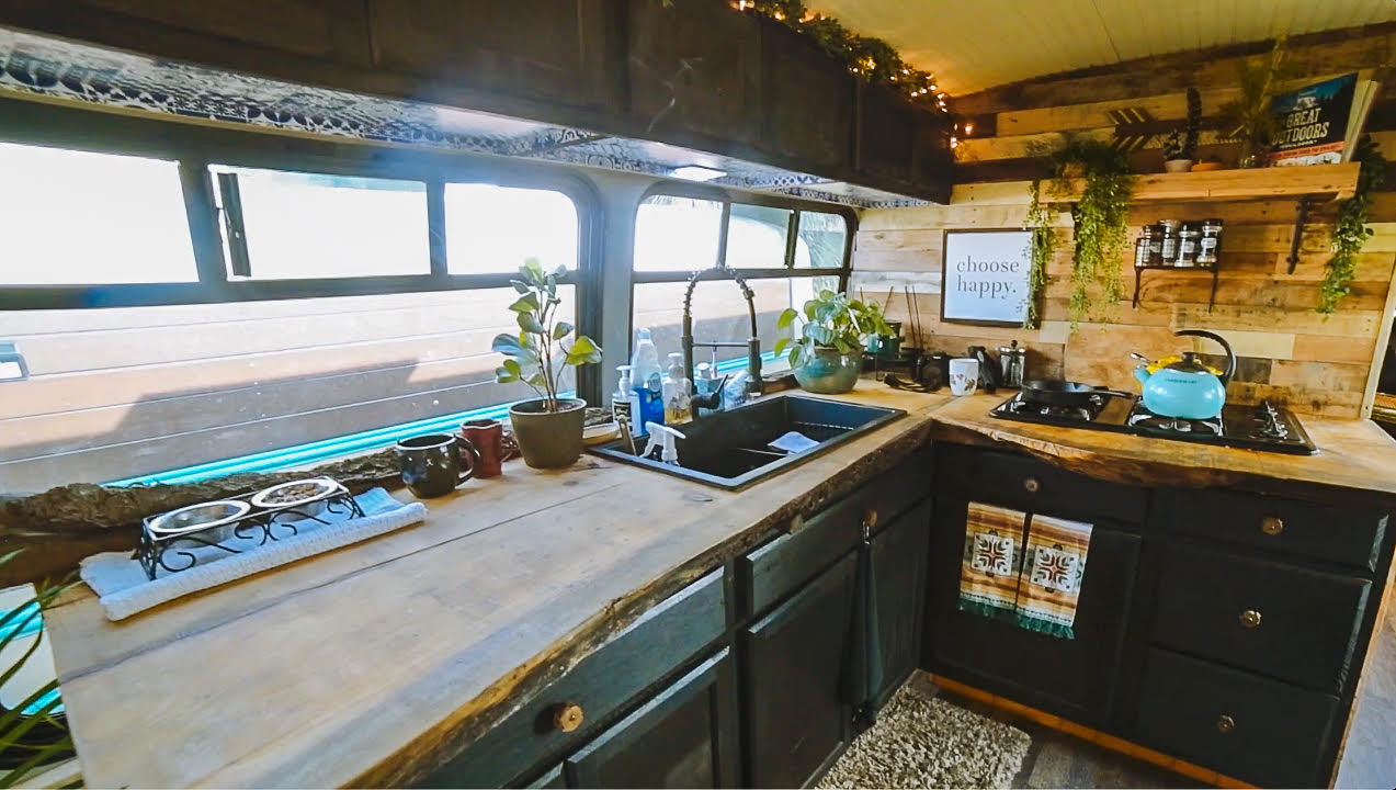 Boho Army Green Shuttle Bus Turned Home (& Their Skoolie Biz)